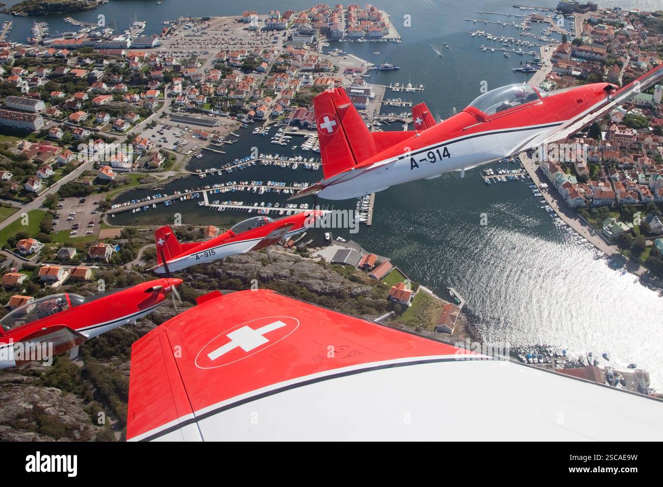 Swiss Air Force PC-7 Team executing synchronized aerobatic maneuvers ...