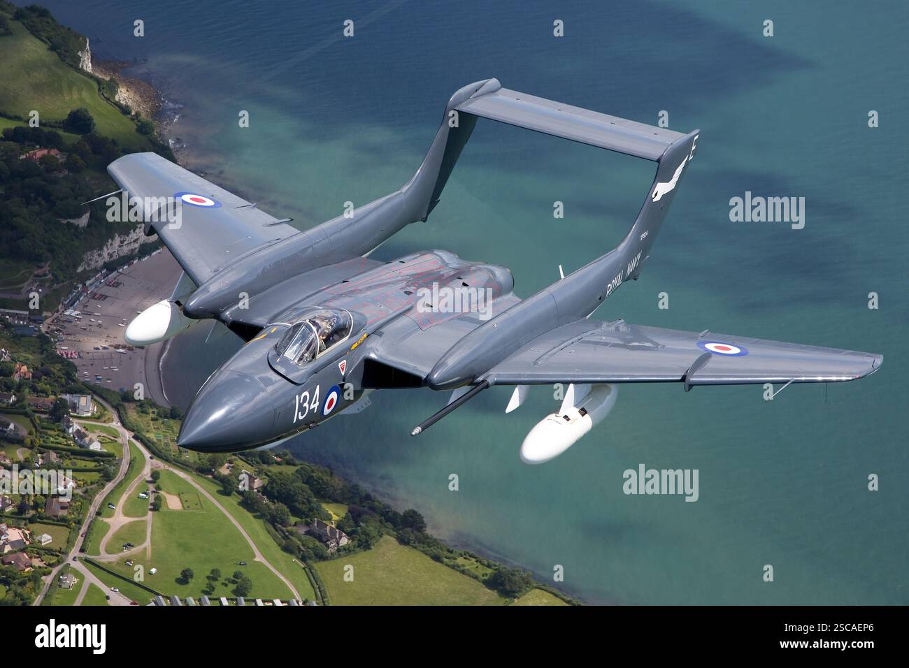 Sea Vixen flying over the ocean, displaying its distinctive twin-boom ...