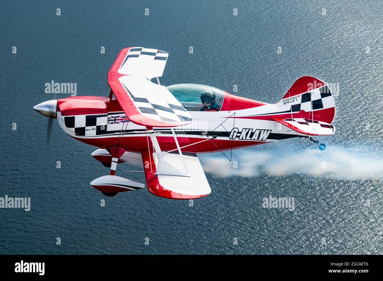 A Pitts Special performing a series of aerobatic maneuvers in flight ...