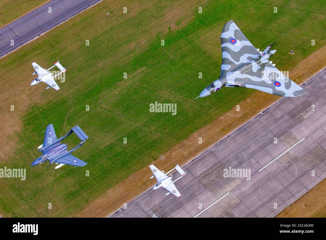 A formation flight featuring a Vulcan bomber, de Havilland Vampire, and ...