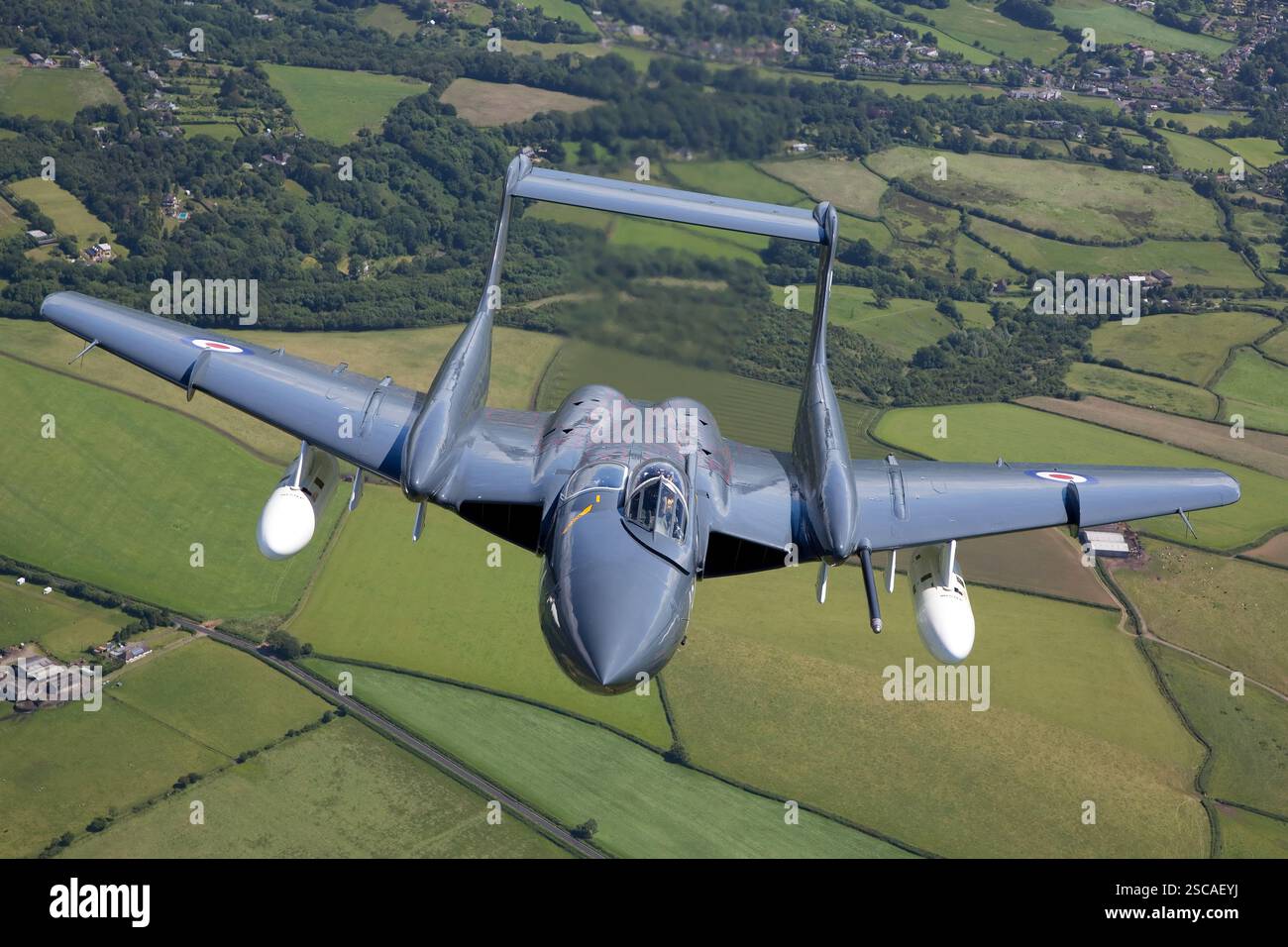 Sea Vixen flying over the ocean, displaying its distinctive twin-boom ...