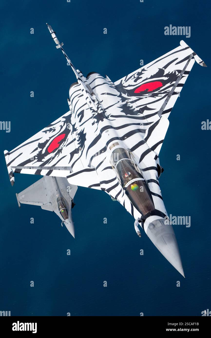 A second shot of a French Air Force Dassault Rafale performing a high ...