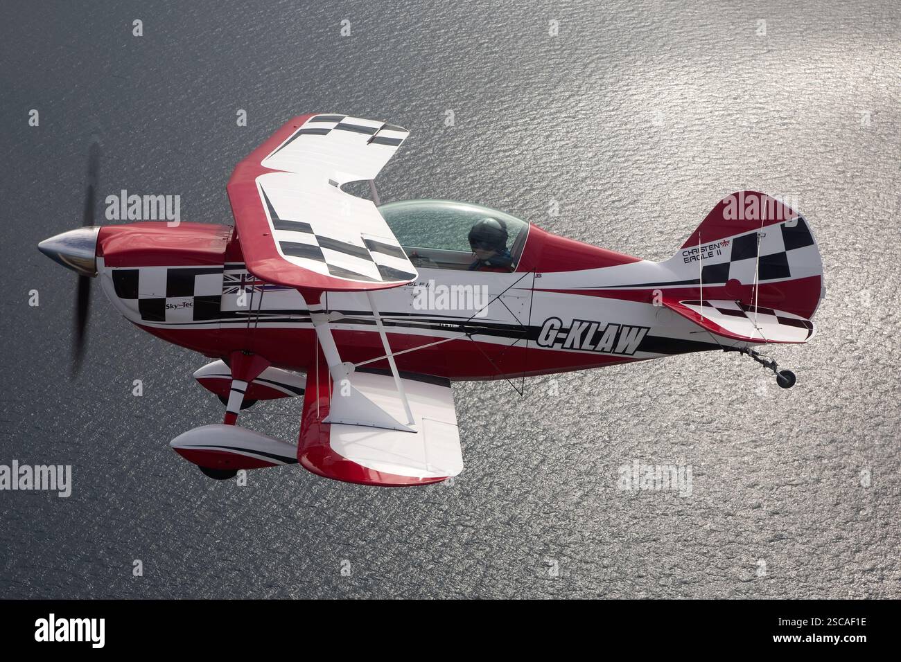 A Pitts Special aerobatic aircraft performing a high-speed roll during ...