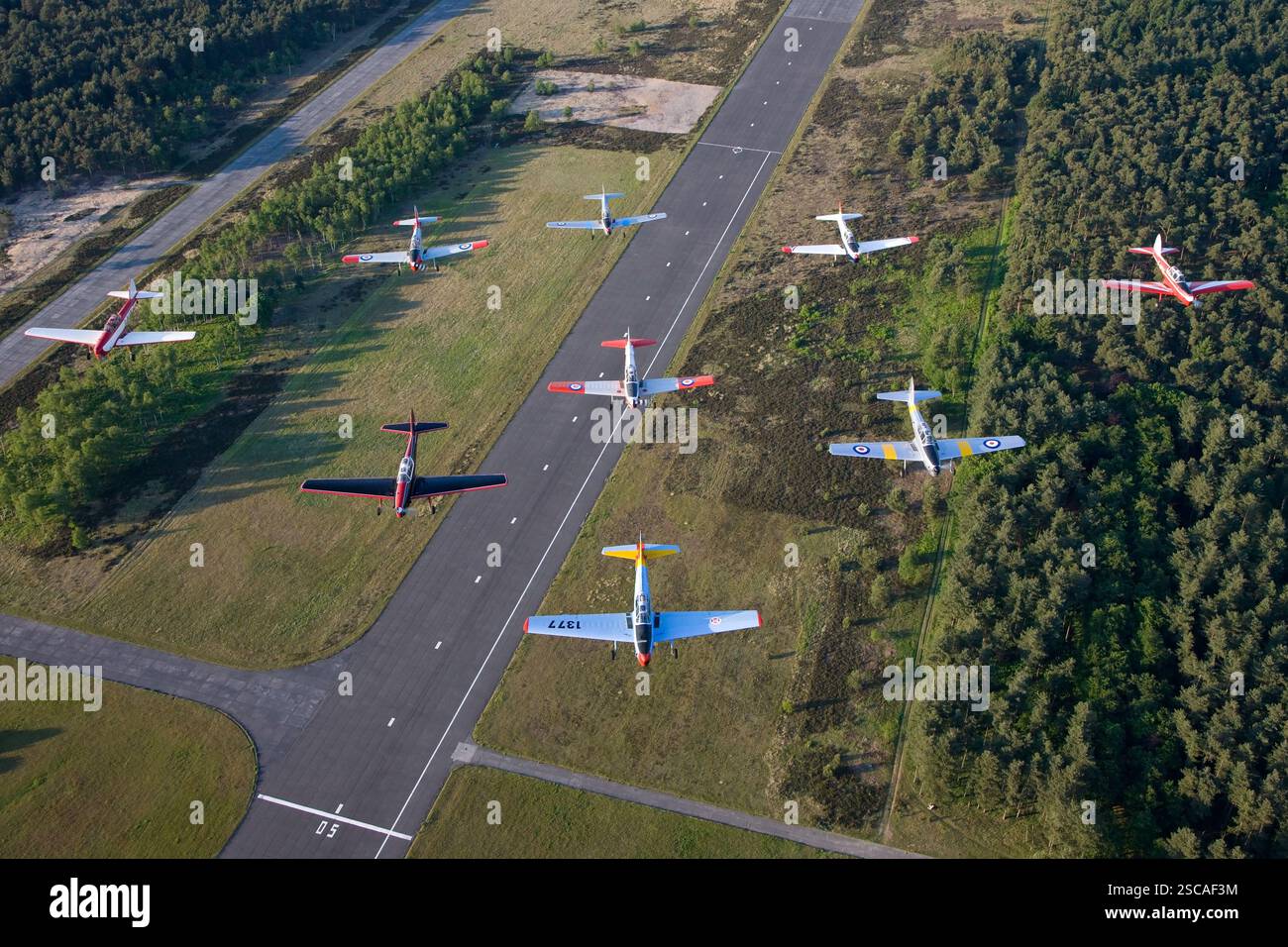 A unique nine-ship formation of DHC-1 Chipmunk aircraft flying in ...