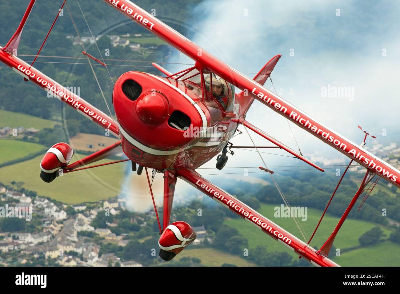 A Pitts Special aerobatic aircraft performing maneuvers in flight. The ...