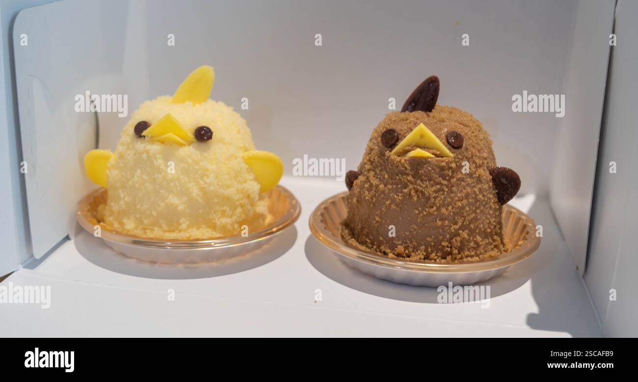 A yellow and a chocolate Nagoya chicken-shaped sweets in a box Stock ...