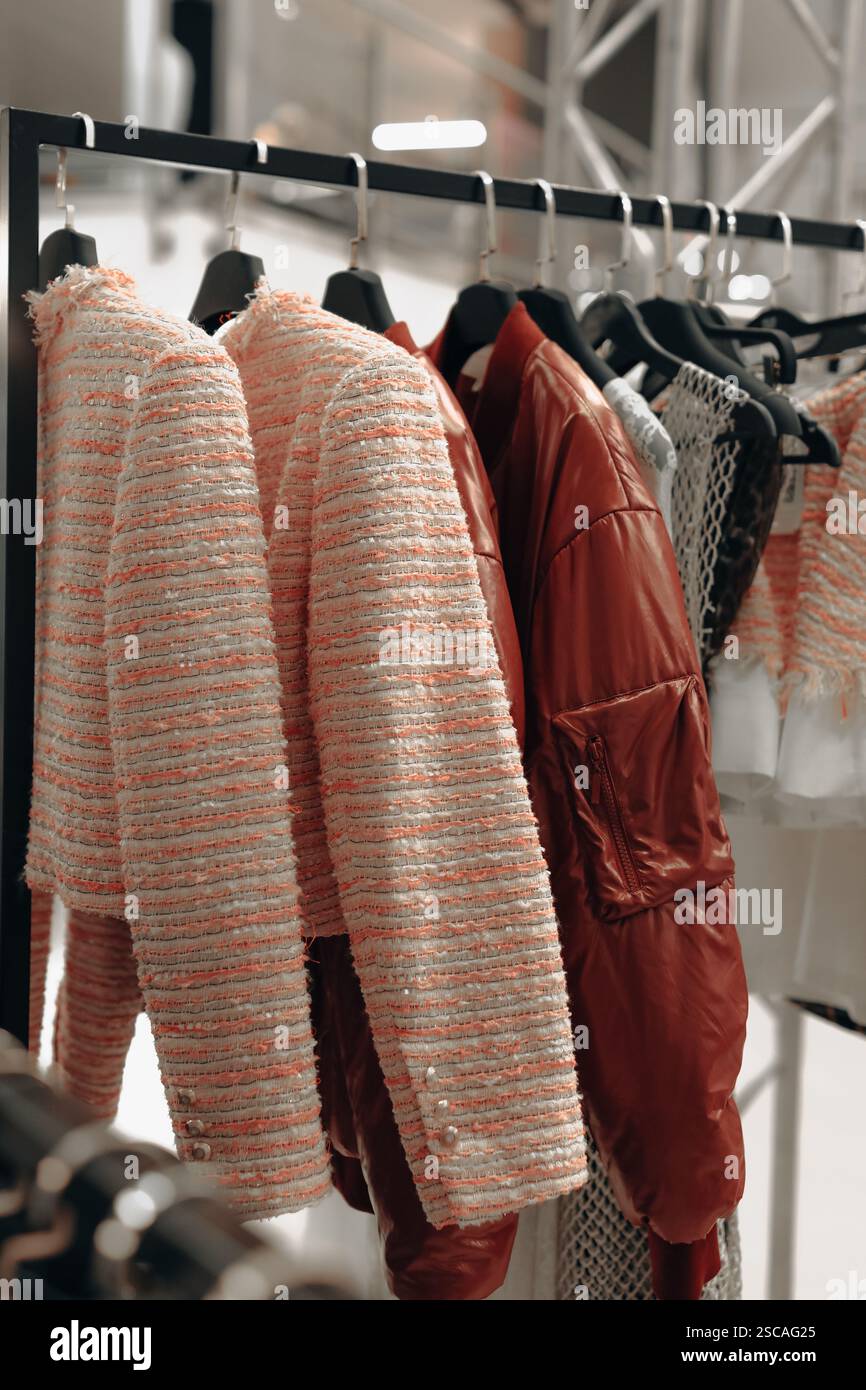 Fashion cloth choice, women's outfits hanging in a row in a luxury ...