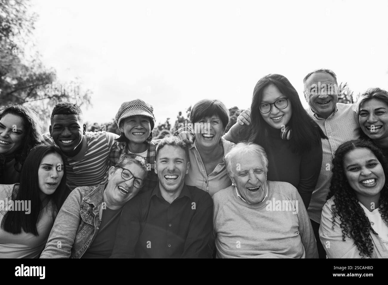 Group of multi generational people smiling in front of camera - Multiracial friends of different ...