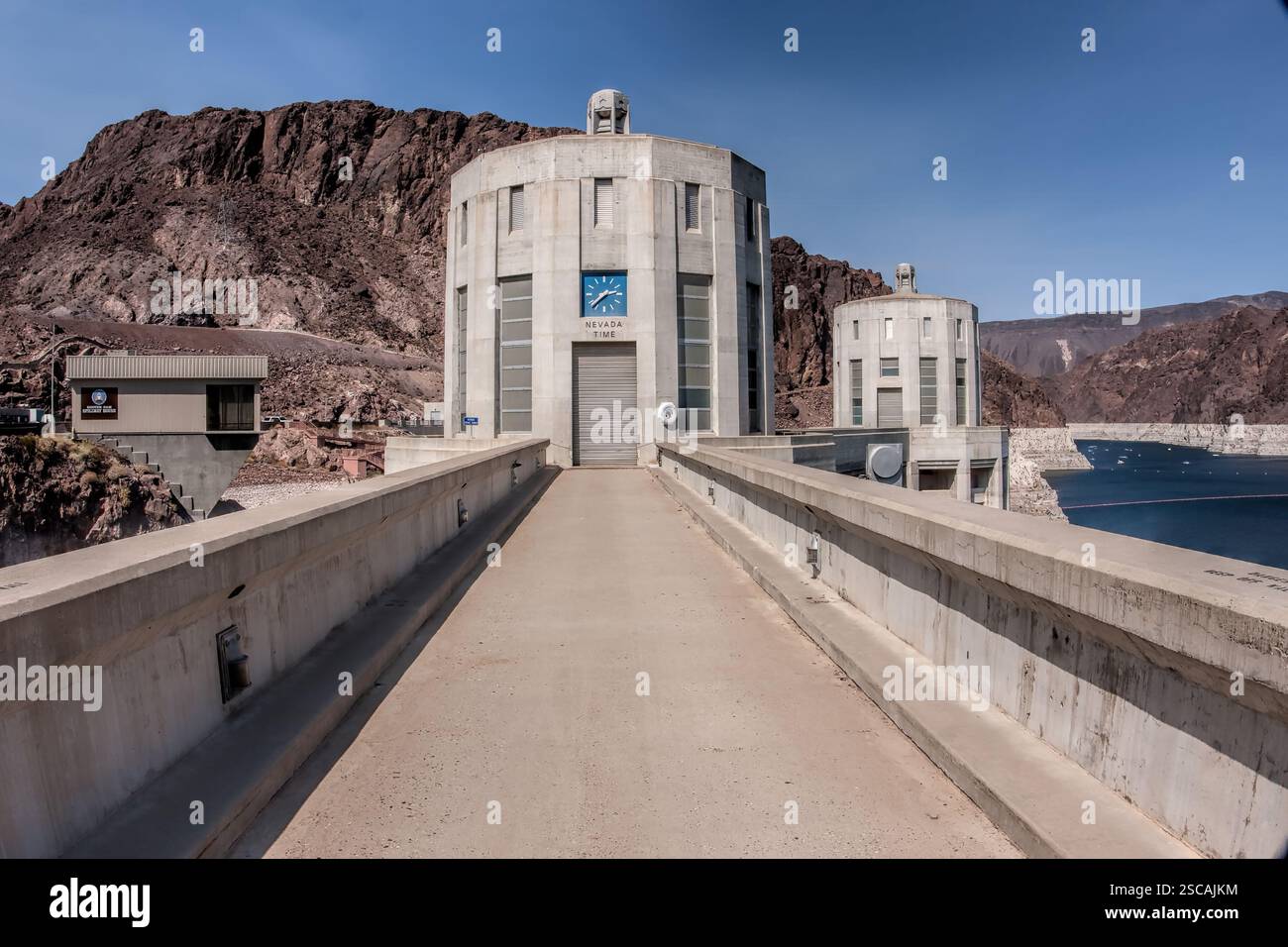 A bridge over a body of water with a clock tower in the background. The ...