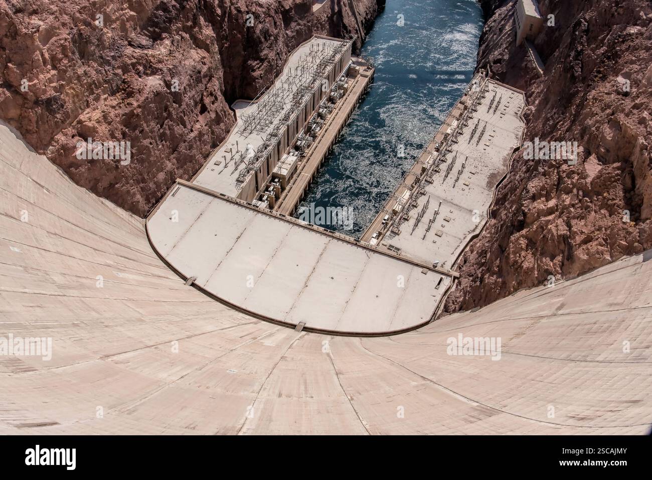 A large dam with a river running through it. The dam is very tall and ...