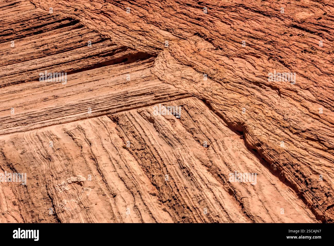 A rocky, brown surface with a few lines. The lines are not straight ...