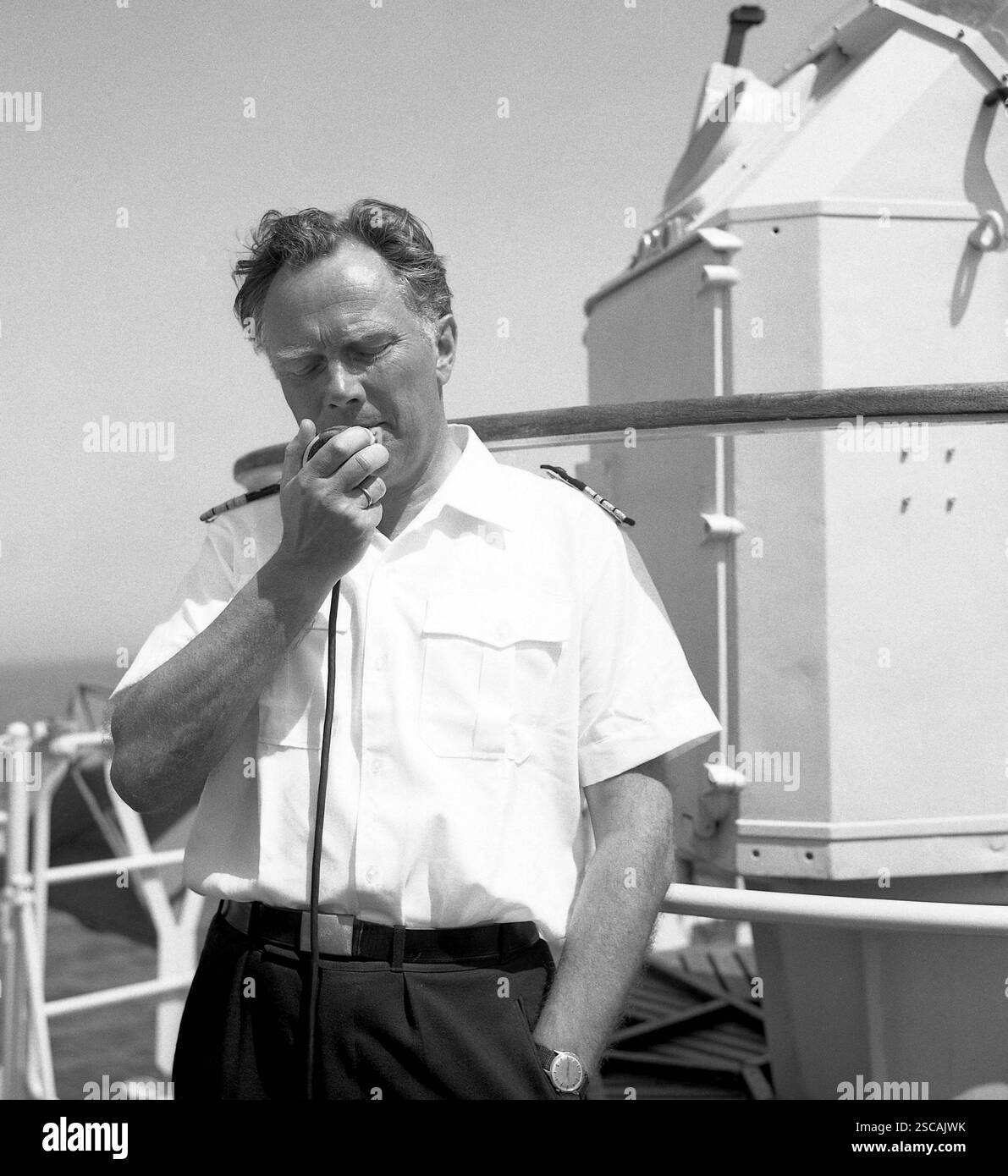 Captain speaking with a microphone on a ship Stock Photo - Alamy