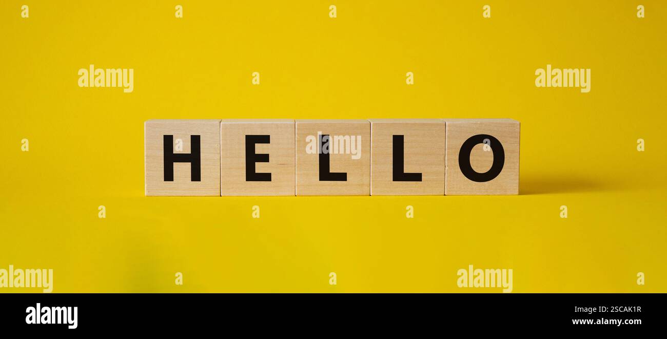 Hello symbol. Wooden cubes with word Hello. Beautiful yellow background ...