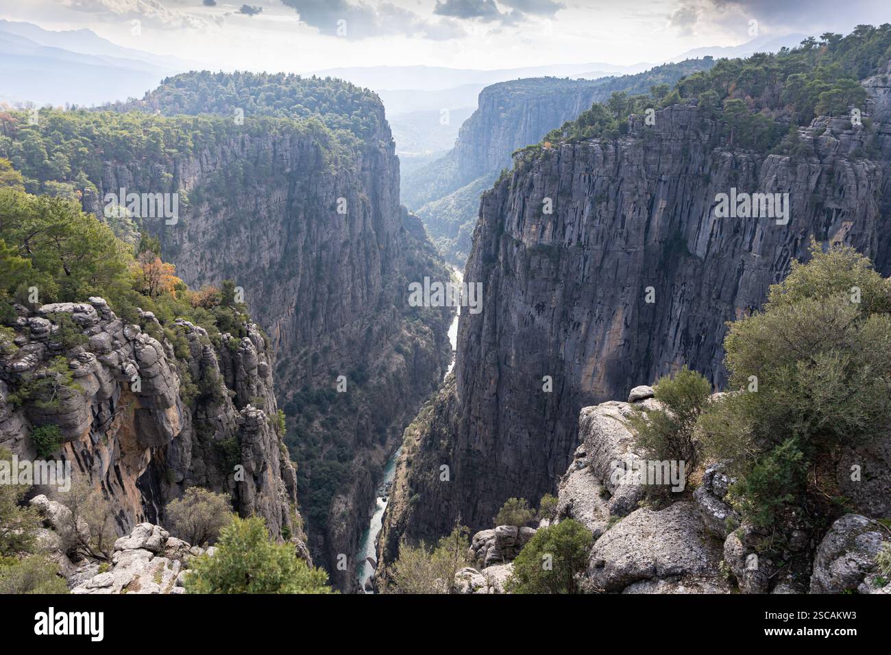 Mountain gorge and a little blue stream flowing between the rocks Stock ...