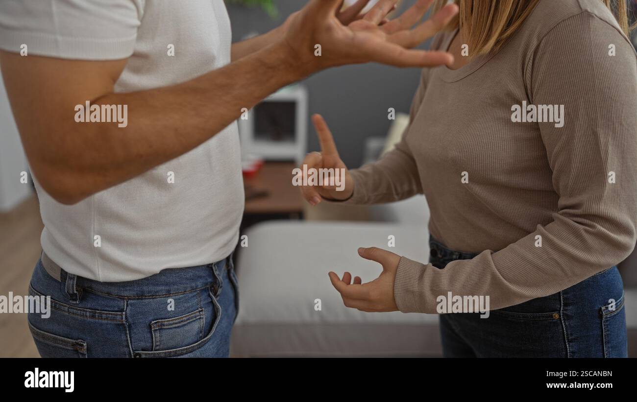 Couple arguing indoors with woman gesturing and man listening ...