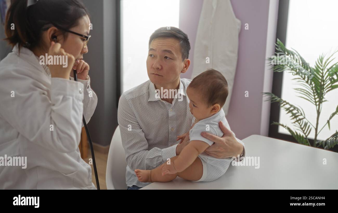 Father holding baby boy while a female doctor listens attentively in a clinic interior ...