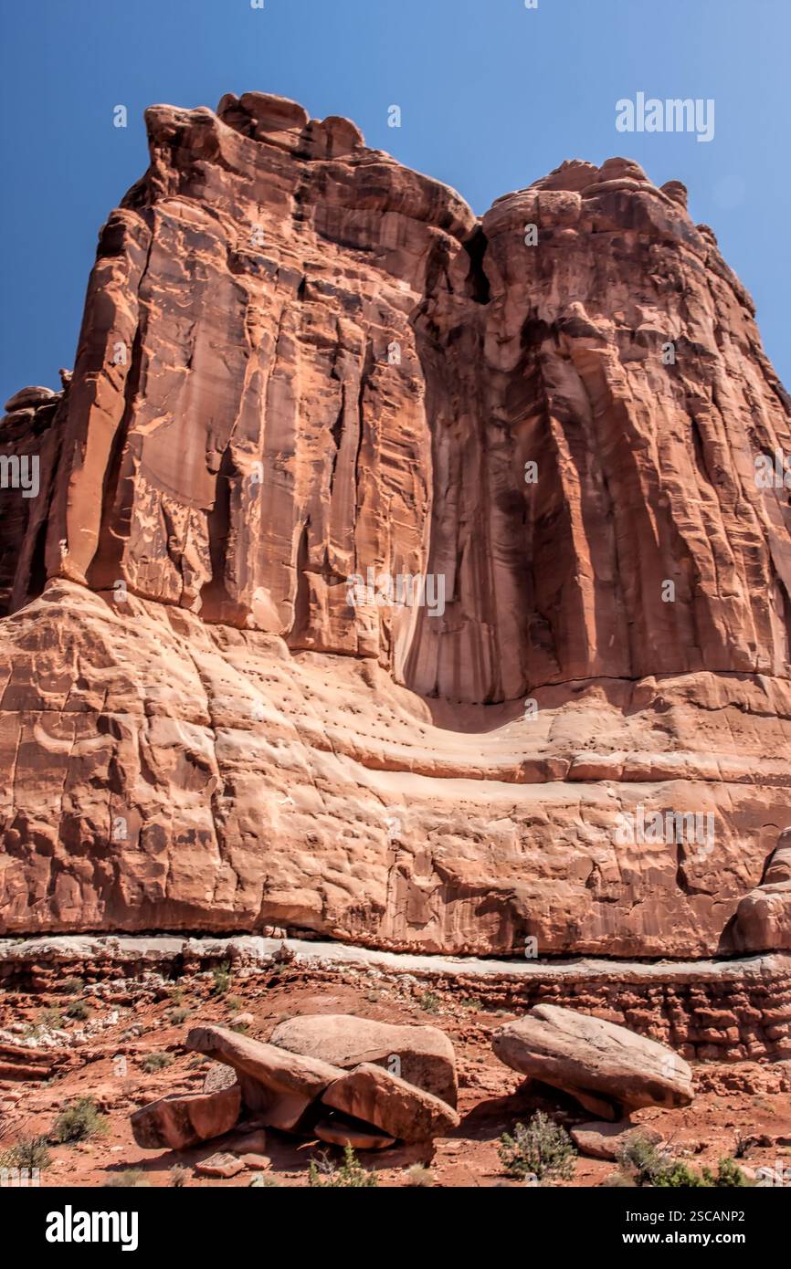 A large rock formation with a path leading up to it. The path is made ...