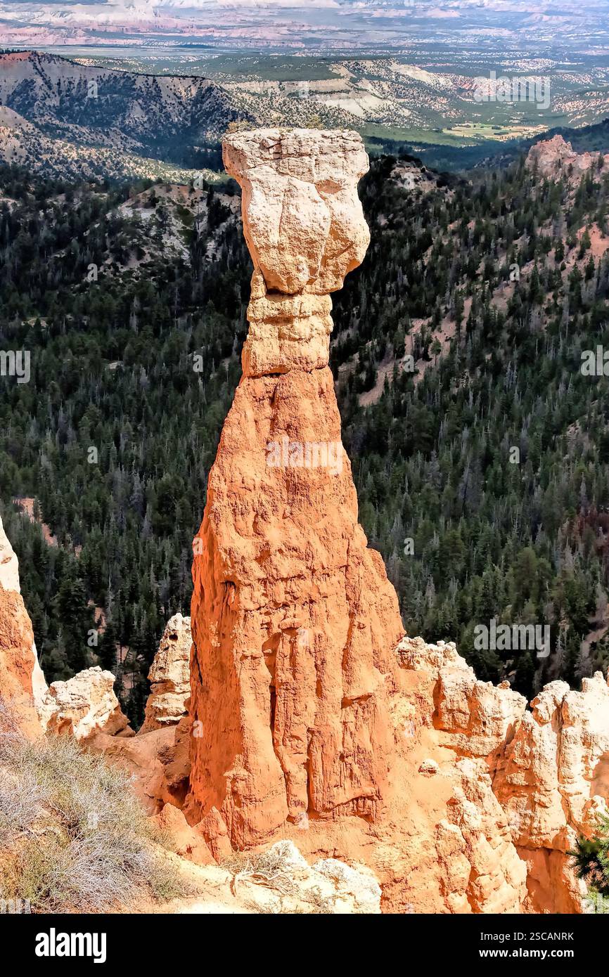 A large rock formation with a pointy top. The rock is brown and white ...