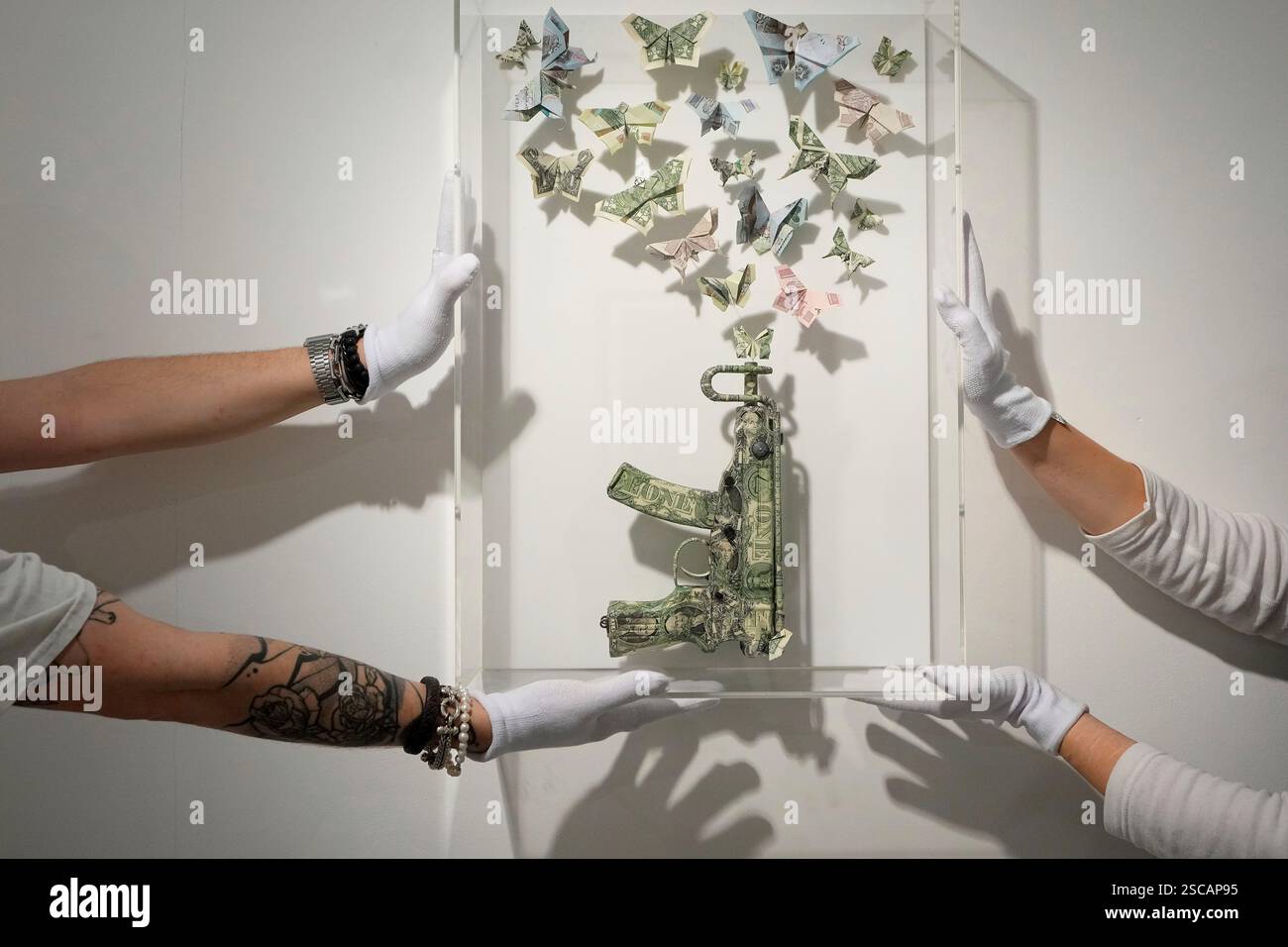 Gallery technicians hang an artwork by British artist and former ...