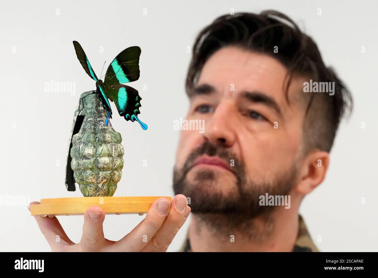 British artist and former Special Forces soldier, Bran, looks at one of ...