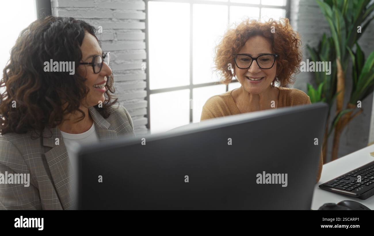 Women collaborating in an office environment with natural light from ...