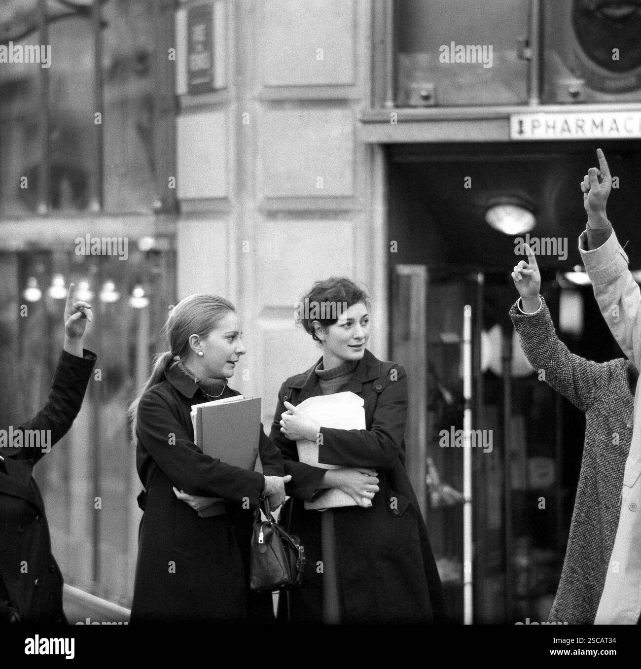 Women with documents and hands pointing with the index finger at the ...