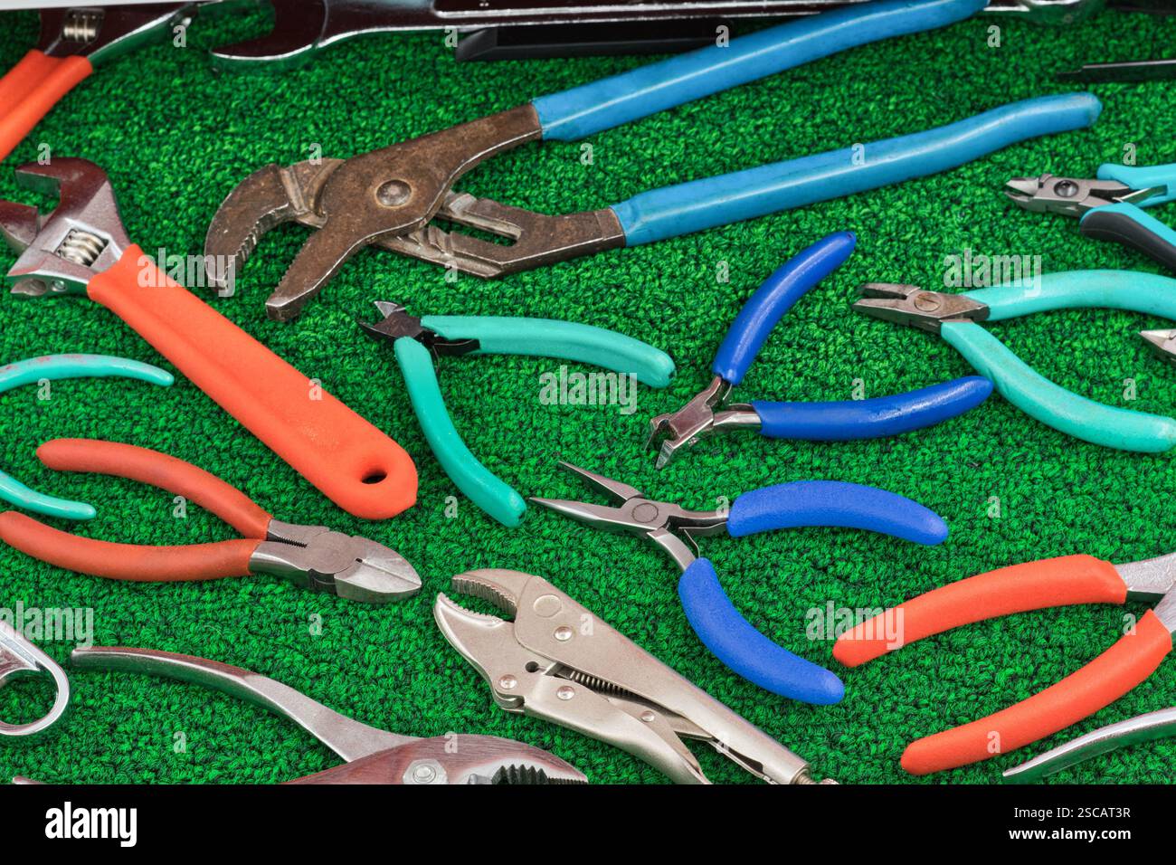 Assorted pliers wrench clamping tools displayed in open toolbox drawer ...