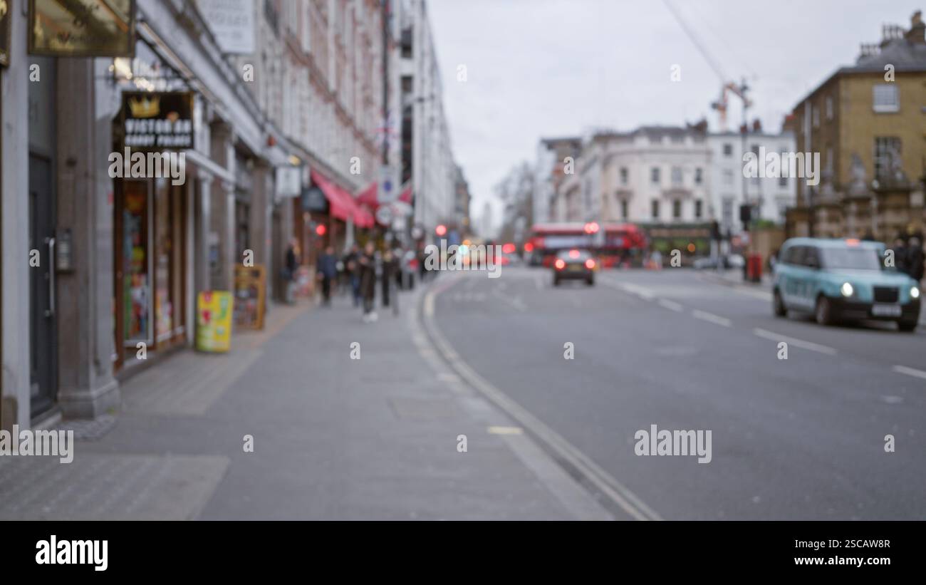 Urban street scene in london with blurred pedestrians and iconic red ...
