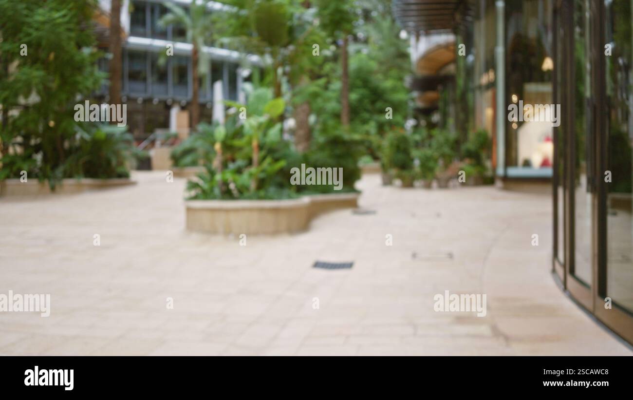 Blurred street scene in monaco with luxury boutiques and greenery ...