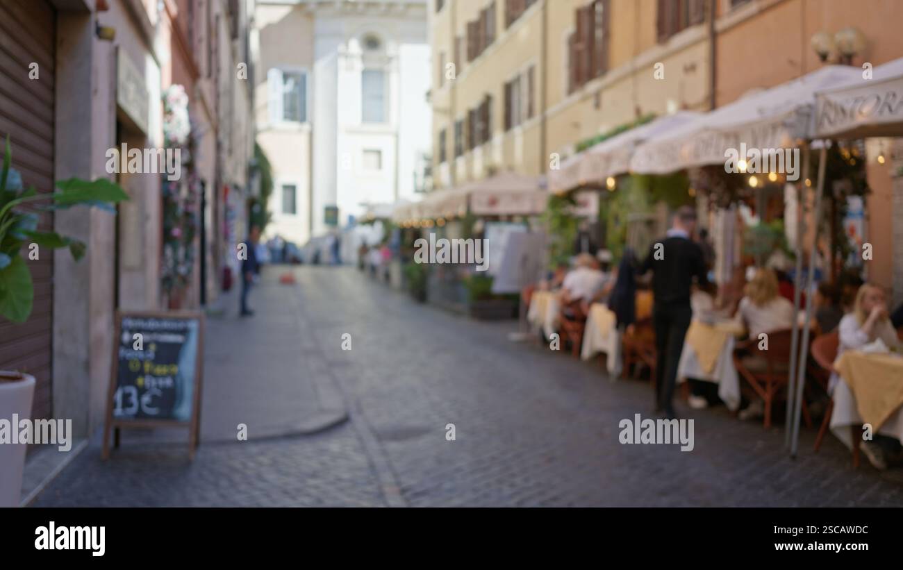 Street view in rome featuring blurred people dining outdoors along a ...