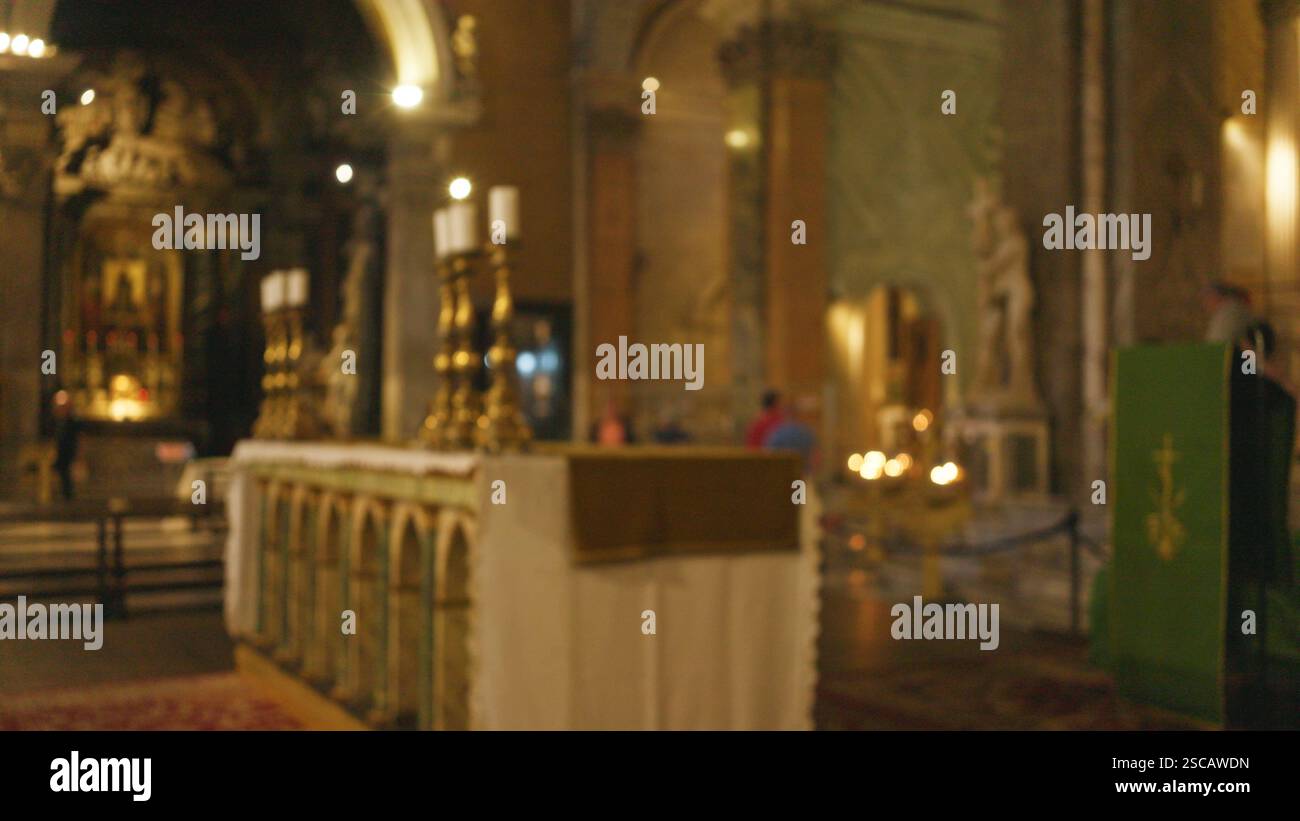 Church interior with blurred candles and altar creates a serene ...