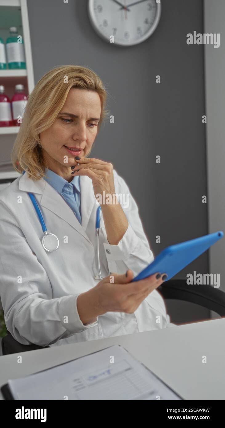 Woman doctor using tablet in hospital room, displaying thoughtful ...