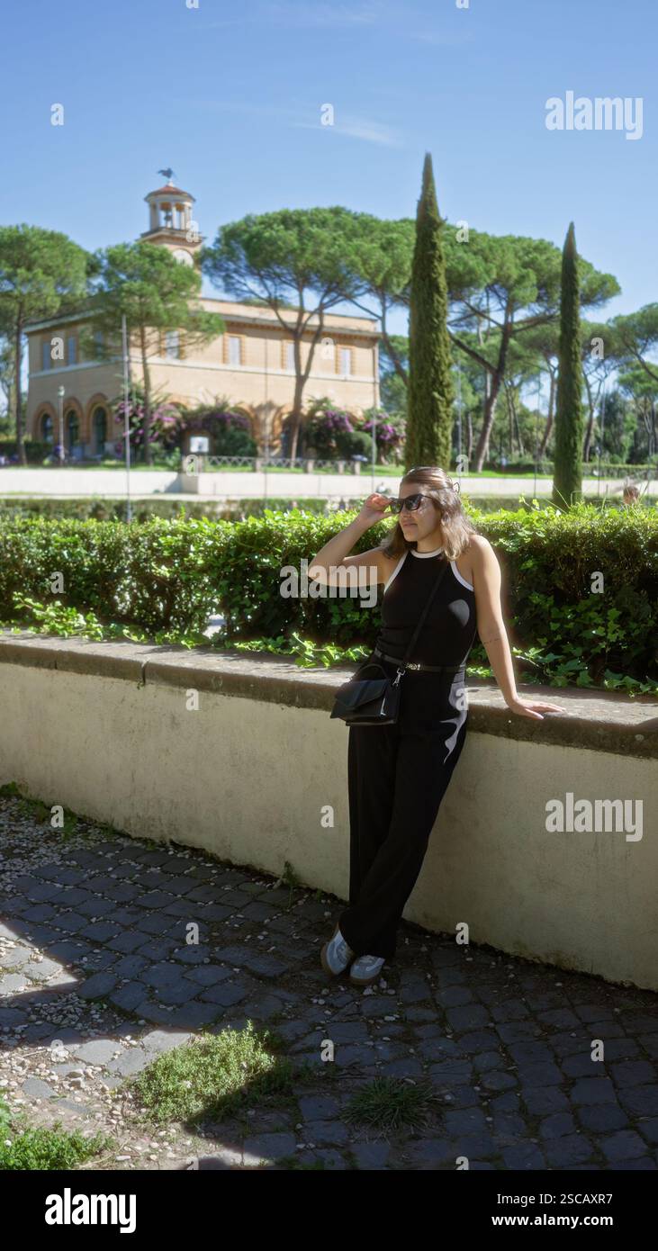 Woman relaxing in villa borghese gardens with lush greenery and ...