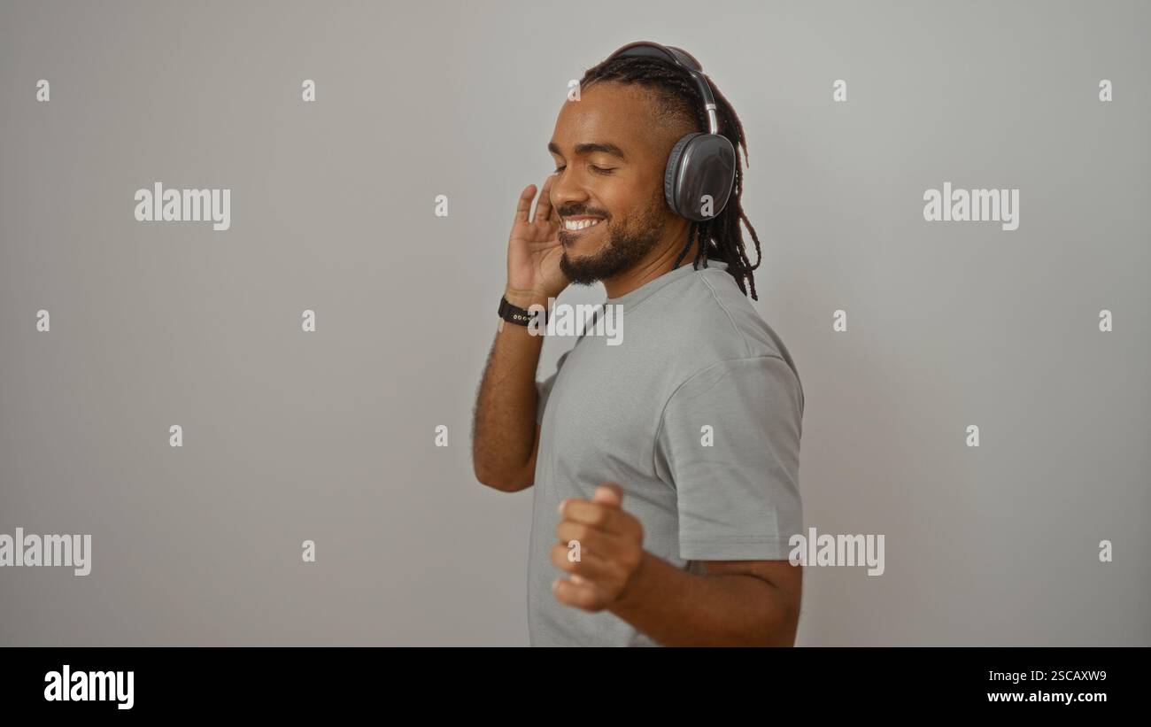 Handsome man dancing joyfully with headphones, expressing happiness ...