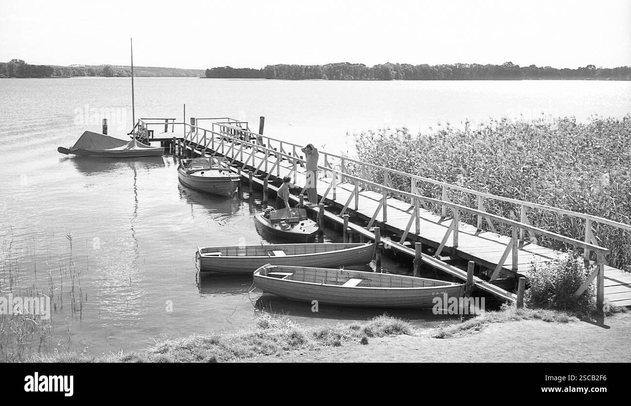 Landing stage with boats at the Pechhuette and Scharmuetzelsee in Bad ...