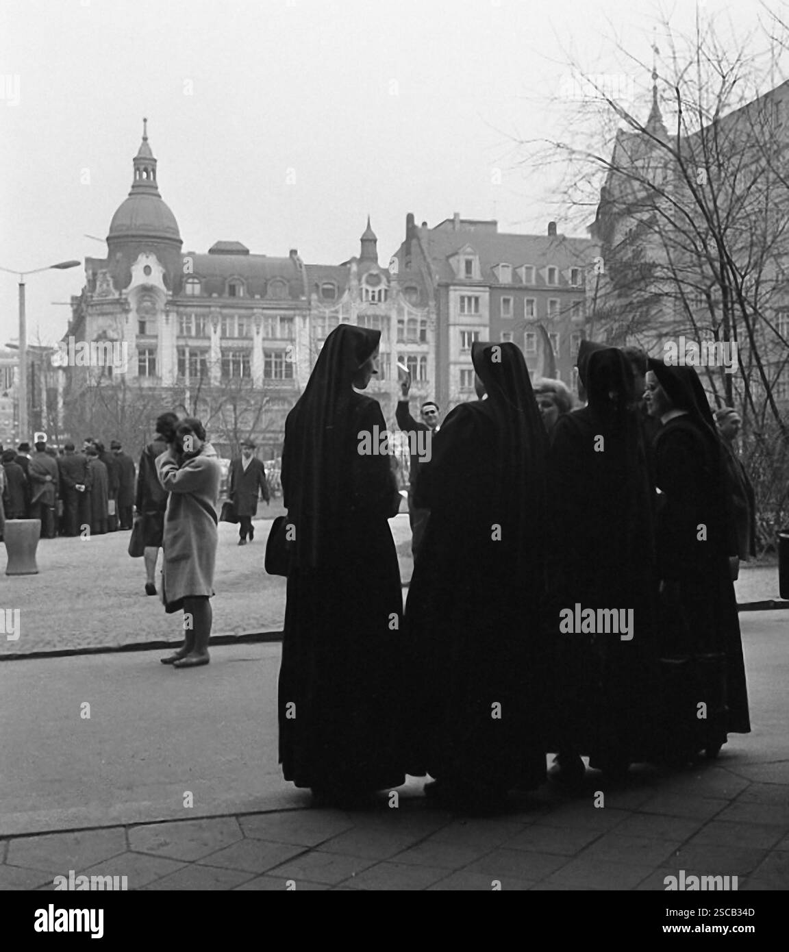 Nuns from behind and a waving man on a square in Leipzig Stock Photo ...
