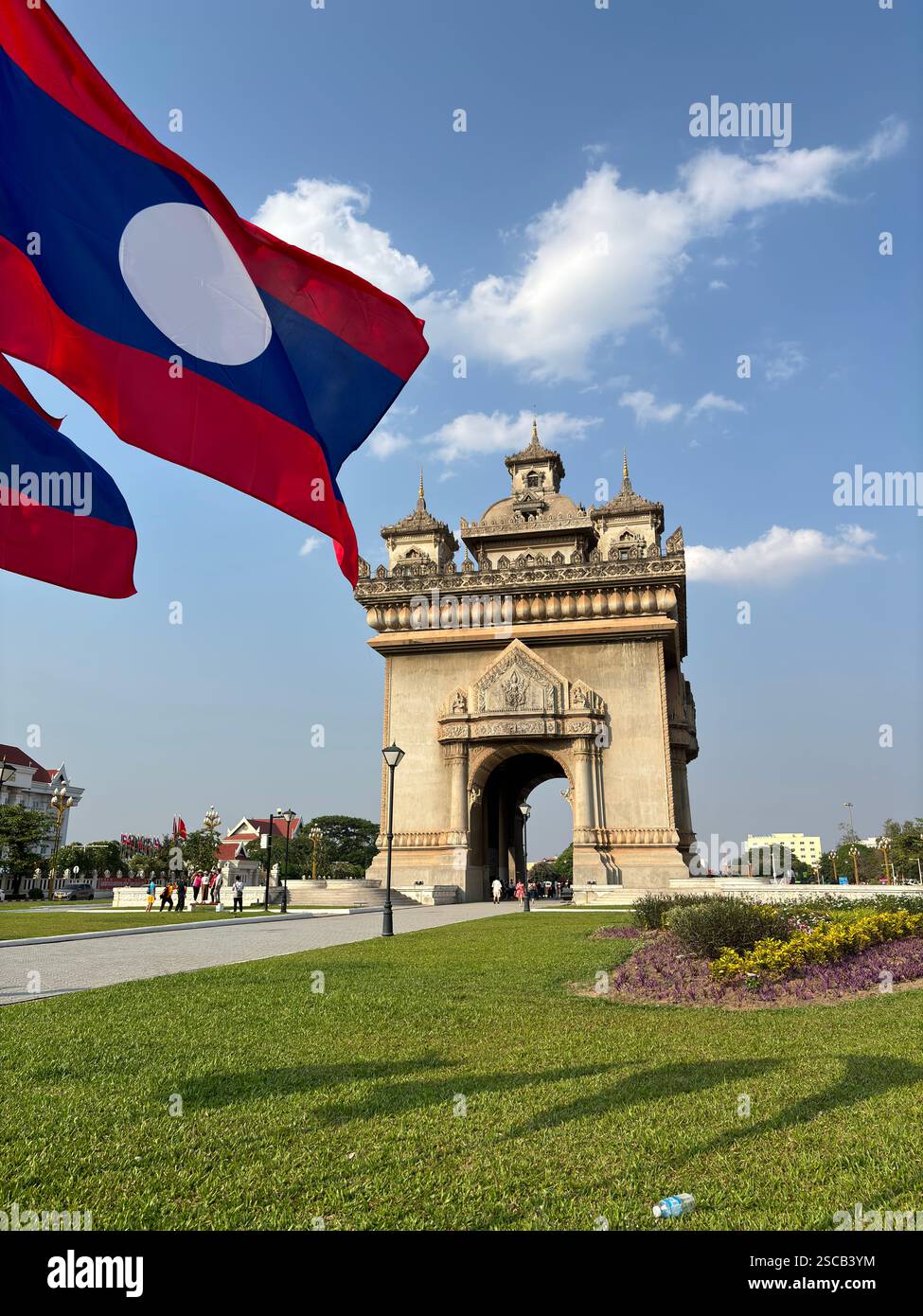 Patuxai Monument with the Lao Flag in Vientiane Stock Photo - Alamy