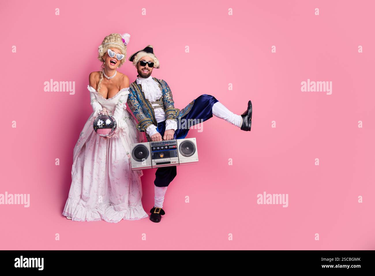 Elegant couple in historical costumes enjoying a fun moment at a themed ...