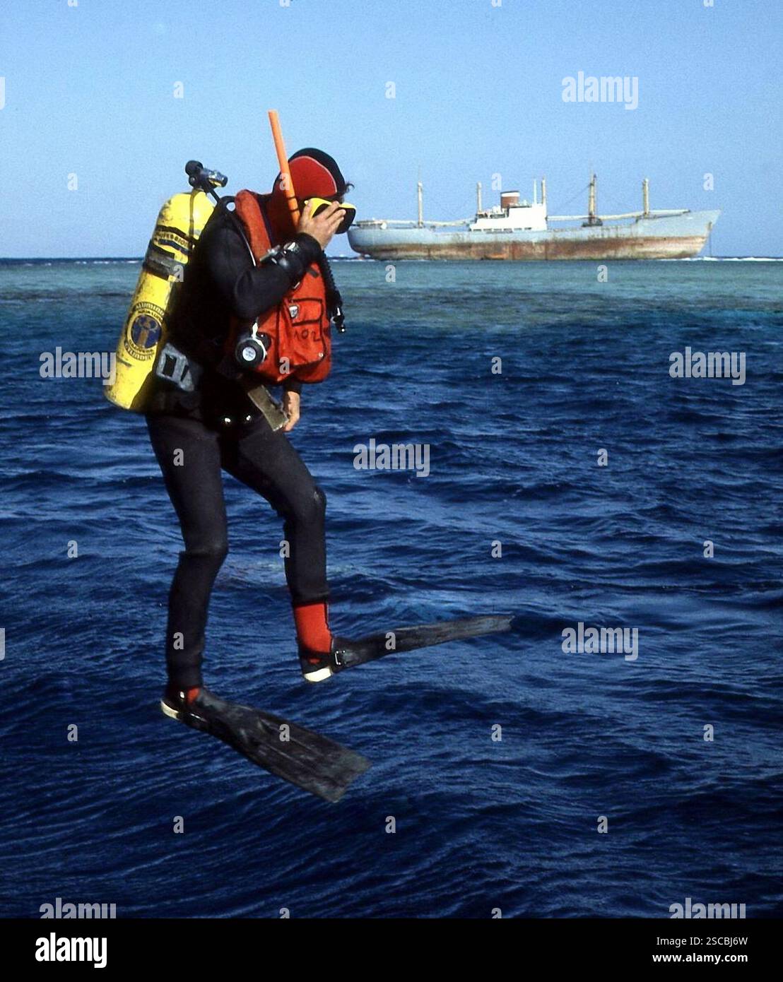 "Diver jumps into the Red Sea near Nabek in Egypt and in the back the ...