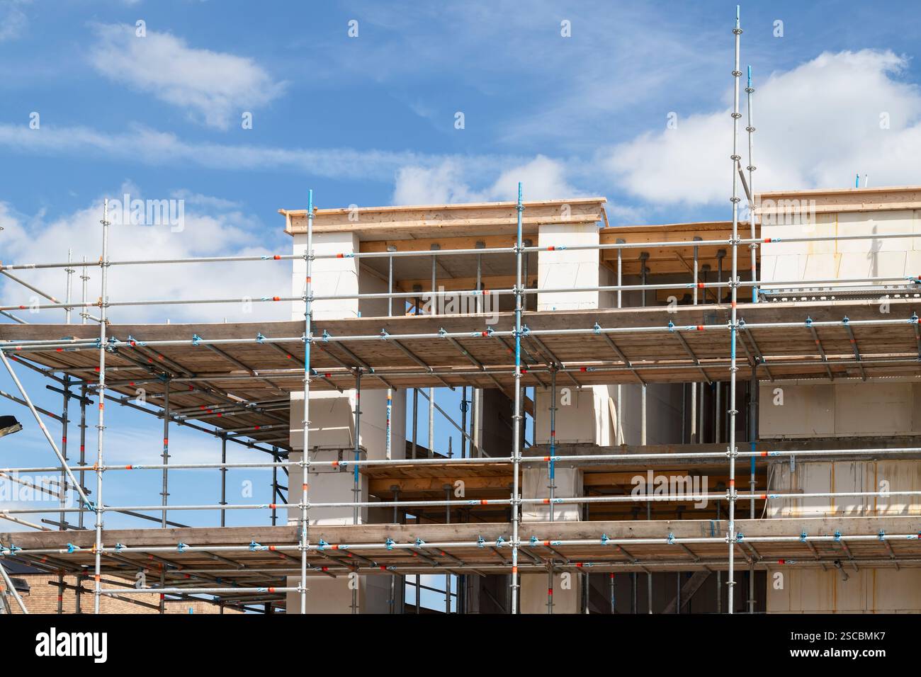 New-build apartment in scaffolding on a construction site of a new ...