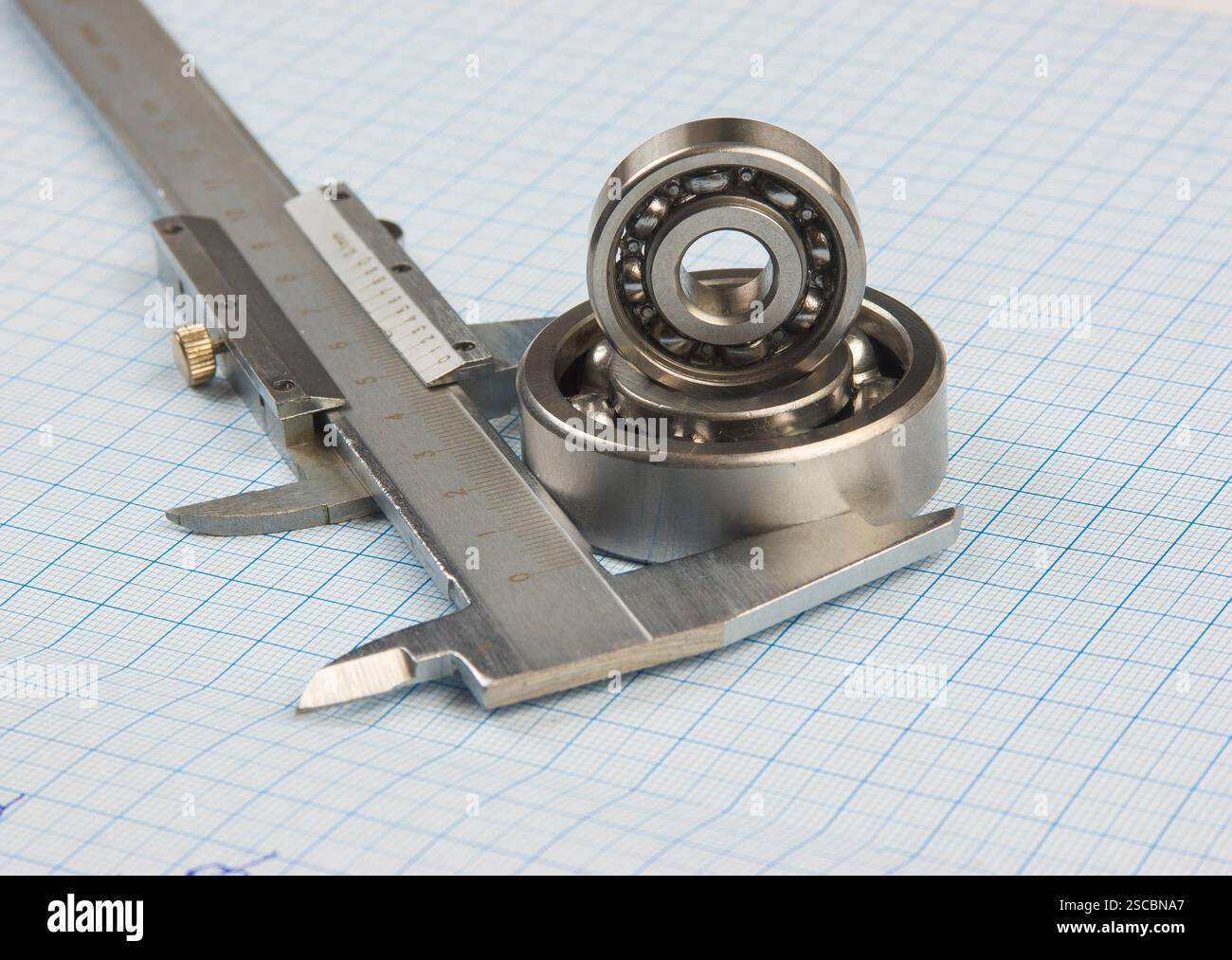 calipers, bearing and square on the background of graph paper Stock ...
