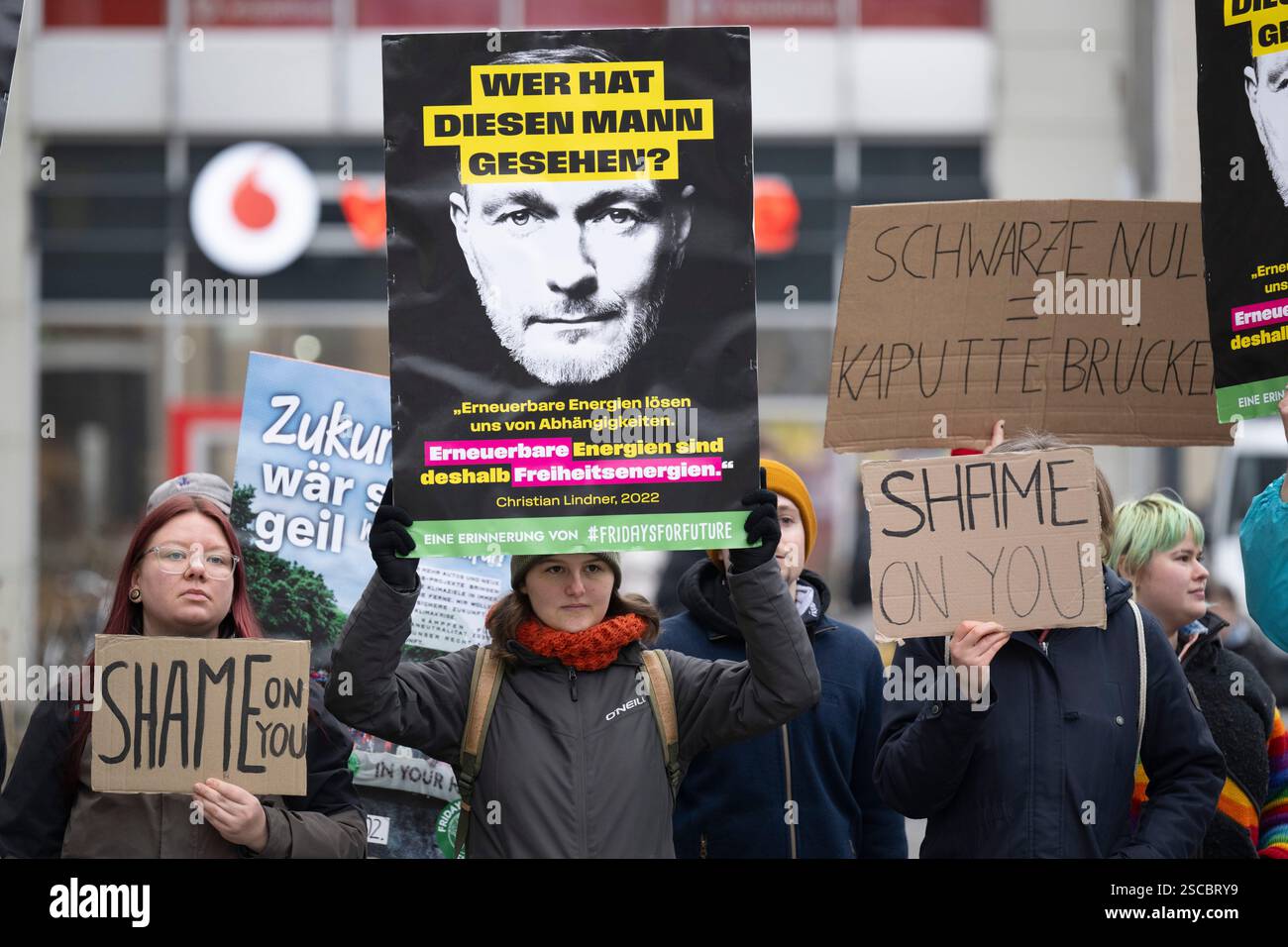 06 February 2025, Saxony, Dresden: Counter-demonstrators hold signs ...