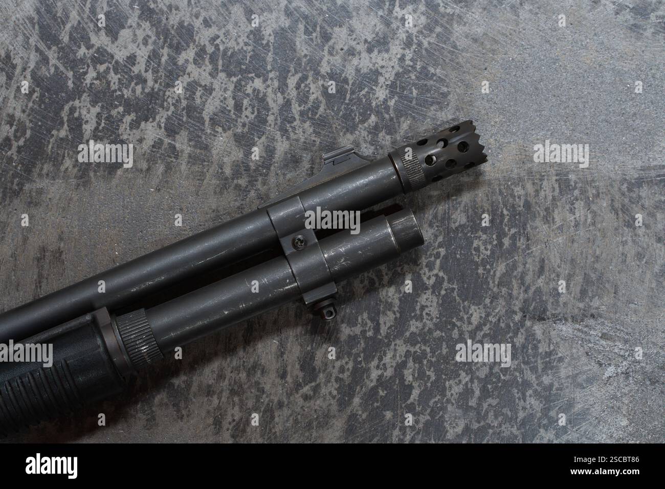 Shotgun barrel with flash hider on concrete floor, close-up photo Stock ...