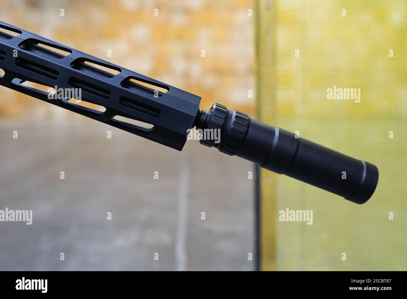 A gun silencer mounted on a modern rifle, close-up photo at a shooting ...