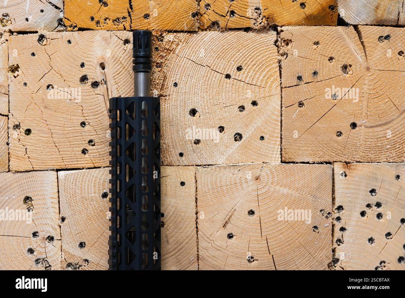 Small arms theme, barrel and fore-end of a tactical rifle near a wooden ...