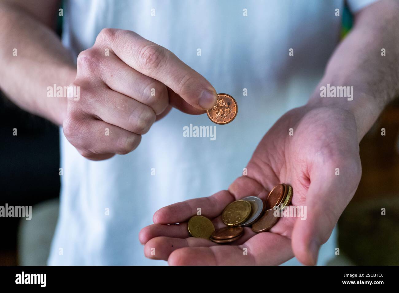 Man holding coins in hands hi-res stock photography and images - Alamy