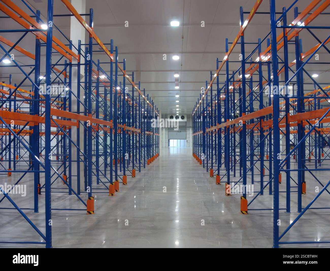 Organized cold storage warehouse with rows of assembled shelving units ...