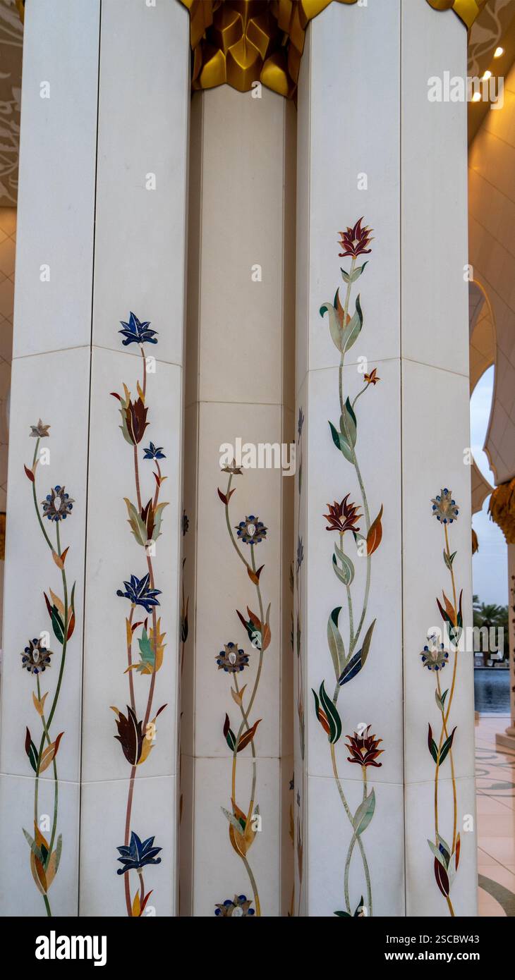 Mosaic of multicolored stones in form of flowers on white marble ...