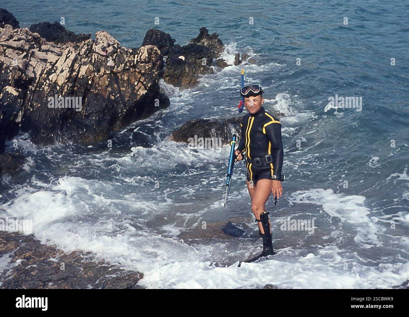 Man wearing diving gear and holding a harpoon for catching octopus at ...
