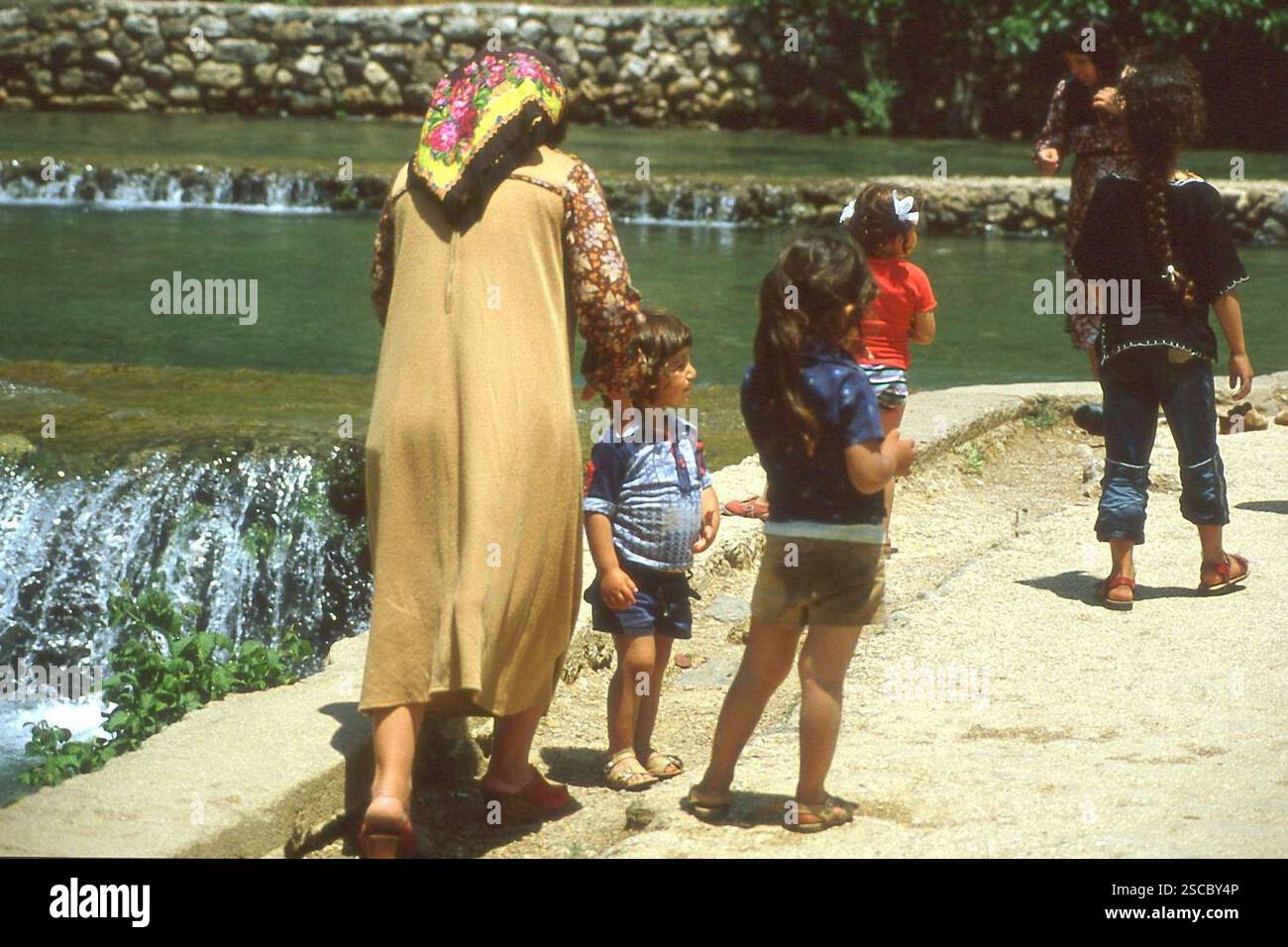 A family near the waterfalls of the river Banyas, also called Hermon ...